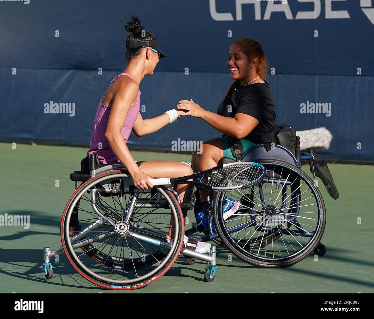 Maylee Phelps and Jade Moreira Lanai react during a junior wheelchair girls' doubles ...