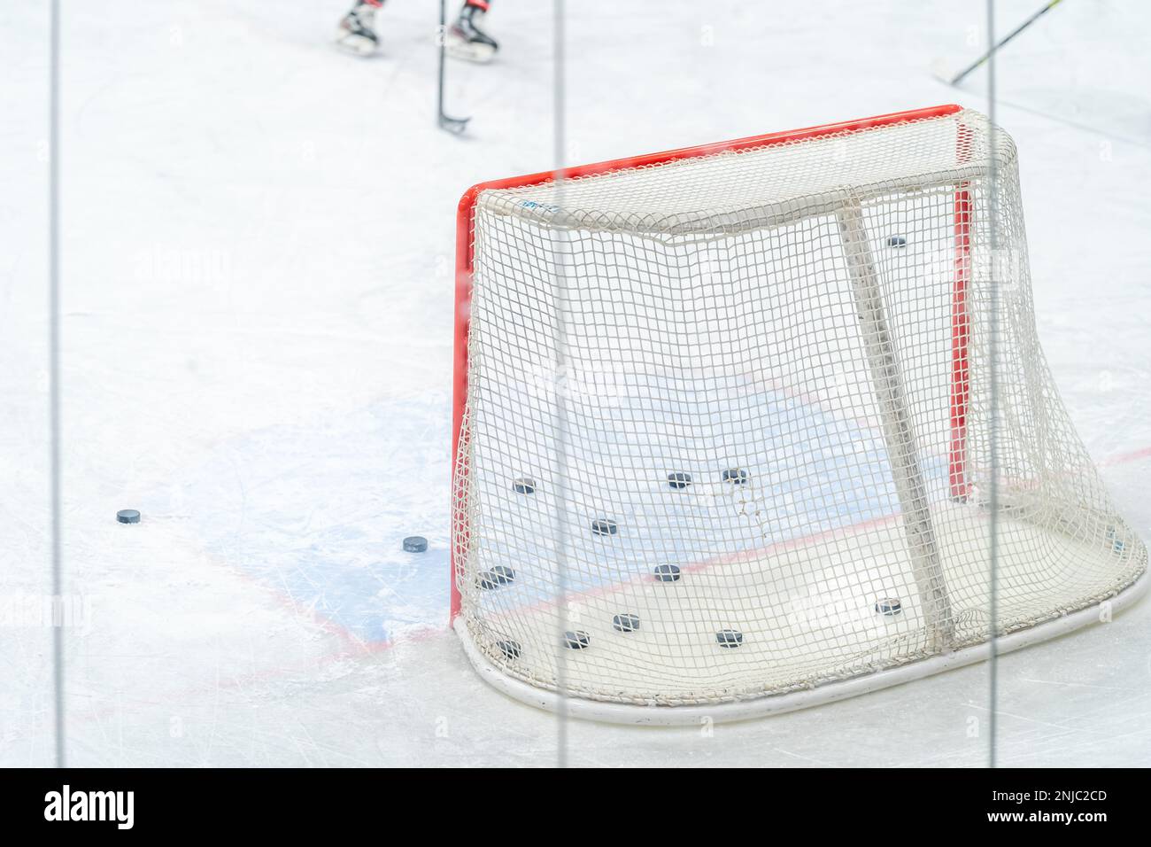 ice hockey goal with pucks, during a hockey players training session ...