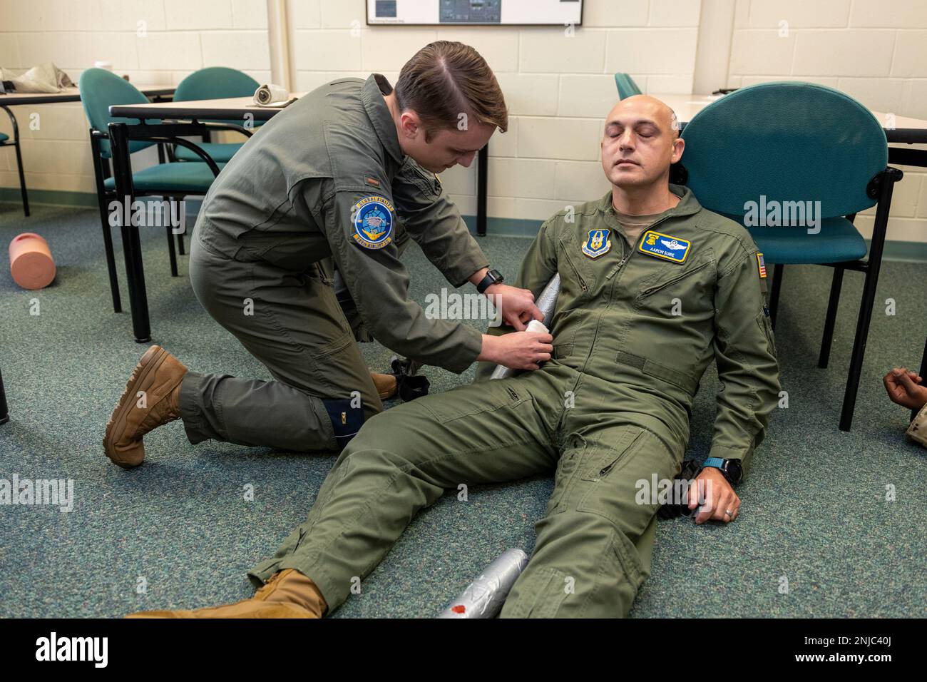 U.S. Air Force 2nd Lt. A.J. Frank, 709th Airlift Squadron, simulates ...