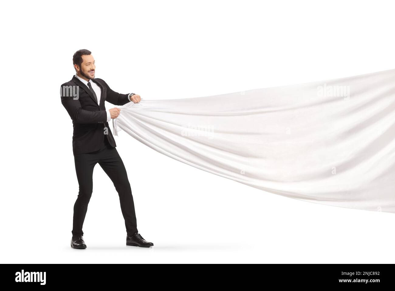 Businessman pulling a big white cloth isolated on white background ...