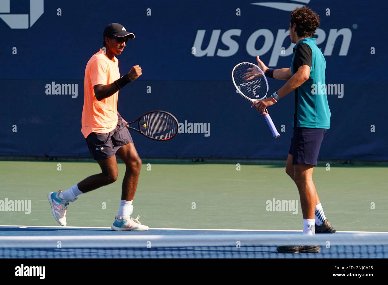 Ozan Baris and Nishesh Basavareddy react during a junior boys' doubles ...