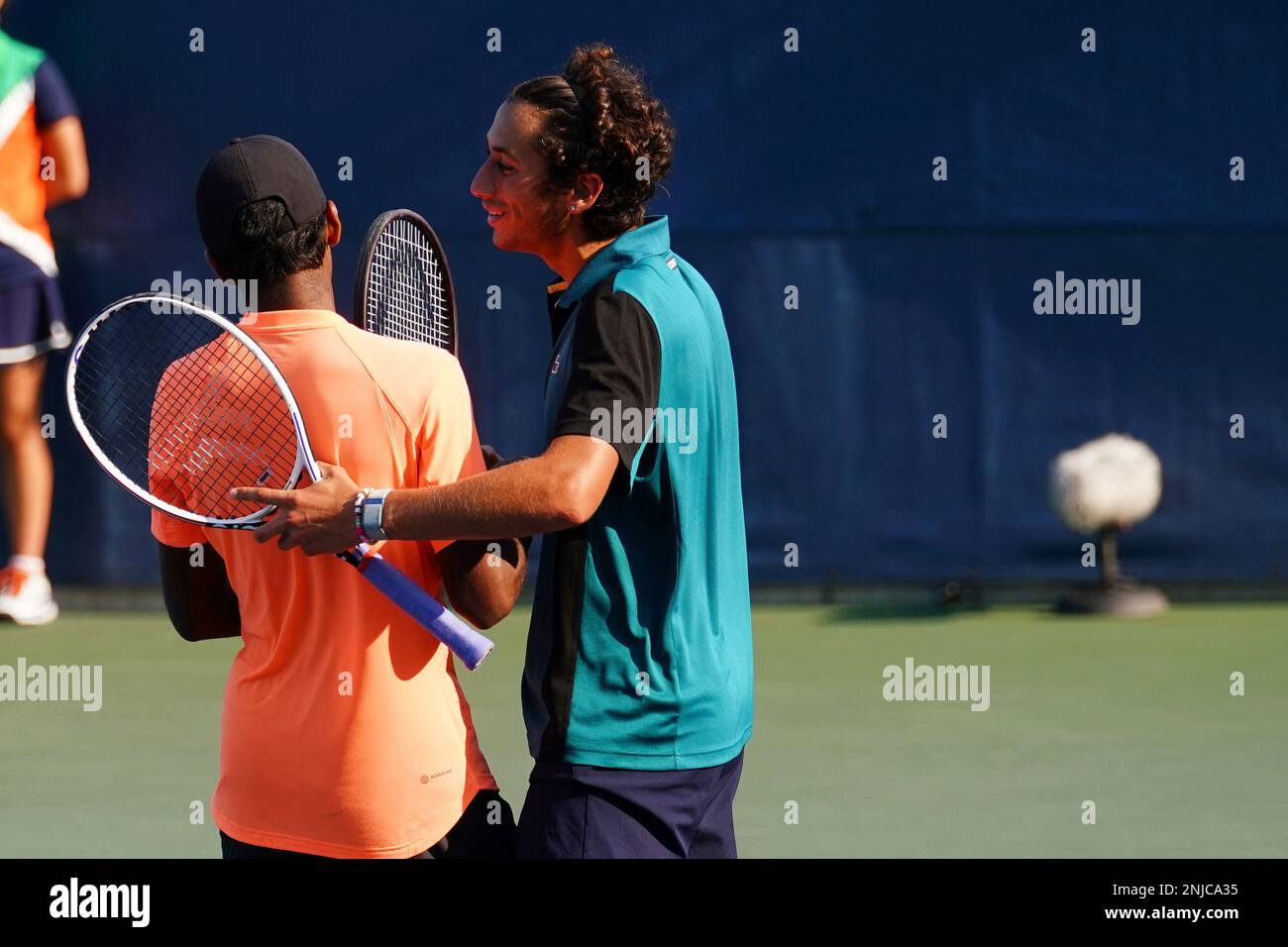 Ozan Baris and Nishesh Basavareddy react during a junior boys' doubles ...
