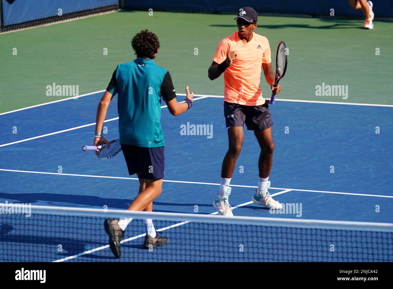 Ozan Baris and Nishesh Basavareddy react during a junior boys' doubles ...