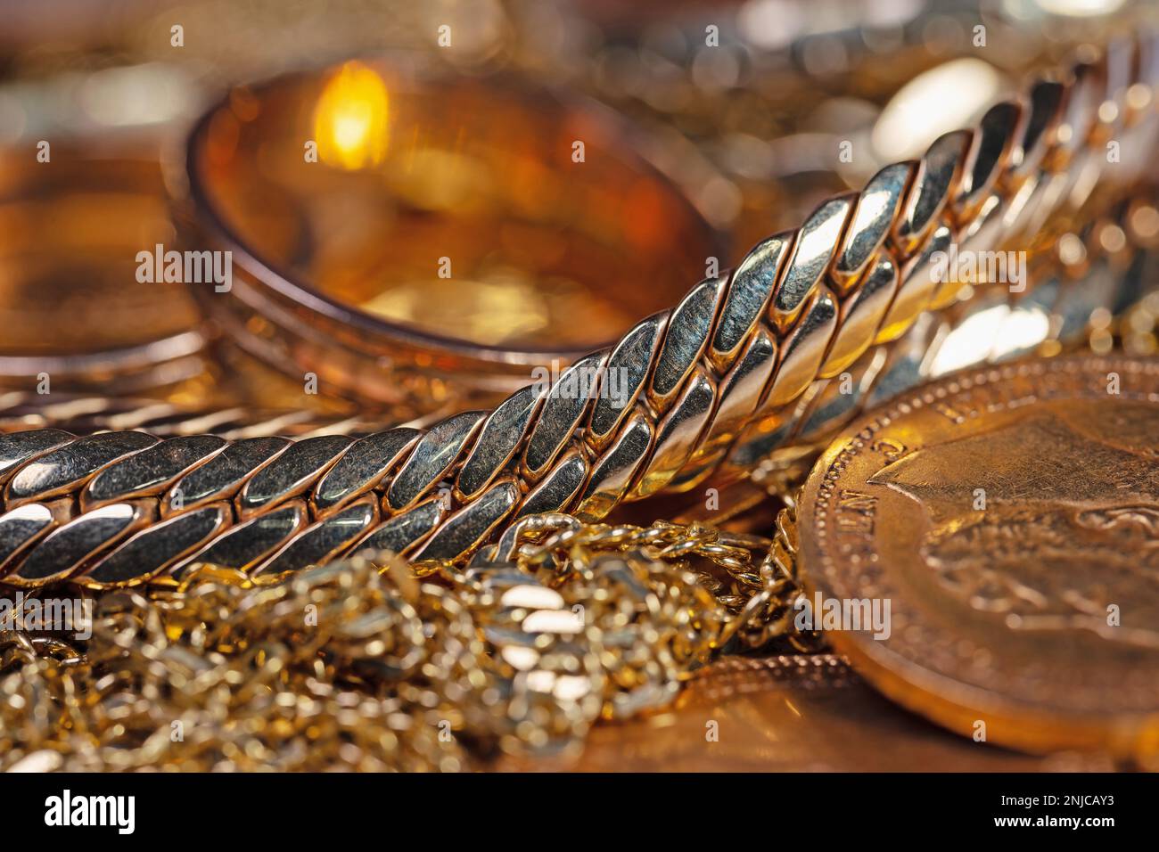 Gold jewelry, gold coins and gold bars in a close-up Stock Photo - Alamy
