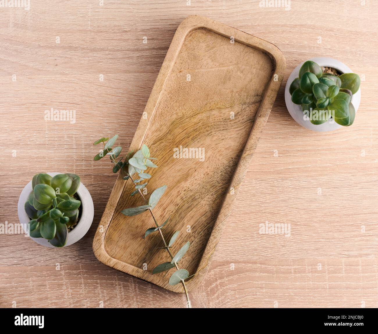 Rectangular wooden stand and eucalyptus branch on the table, background ...