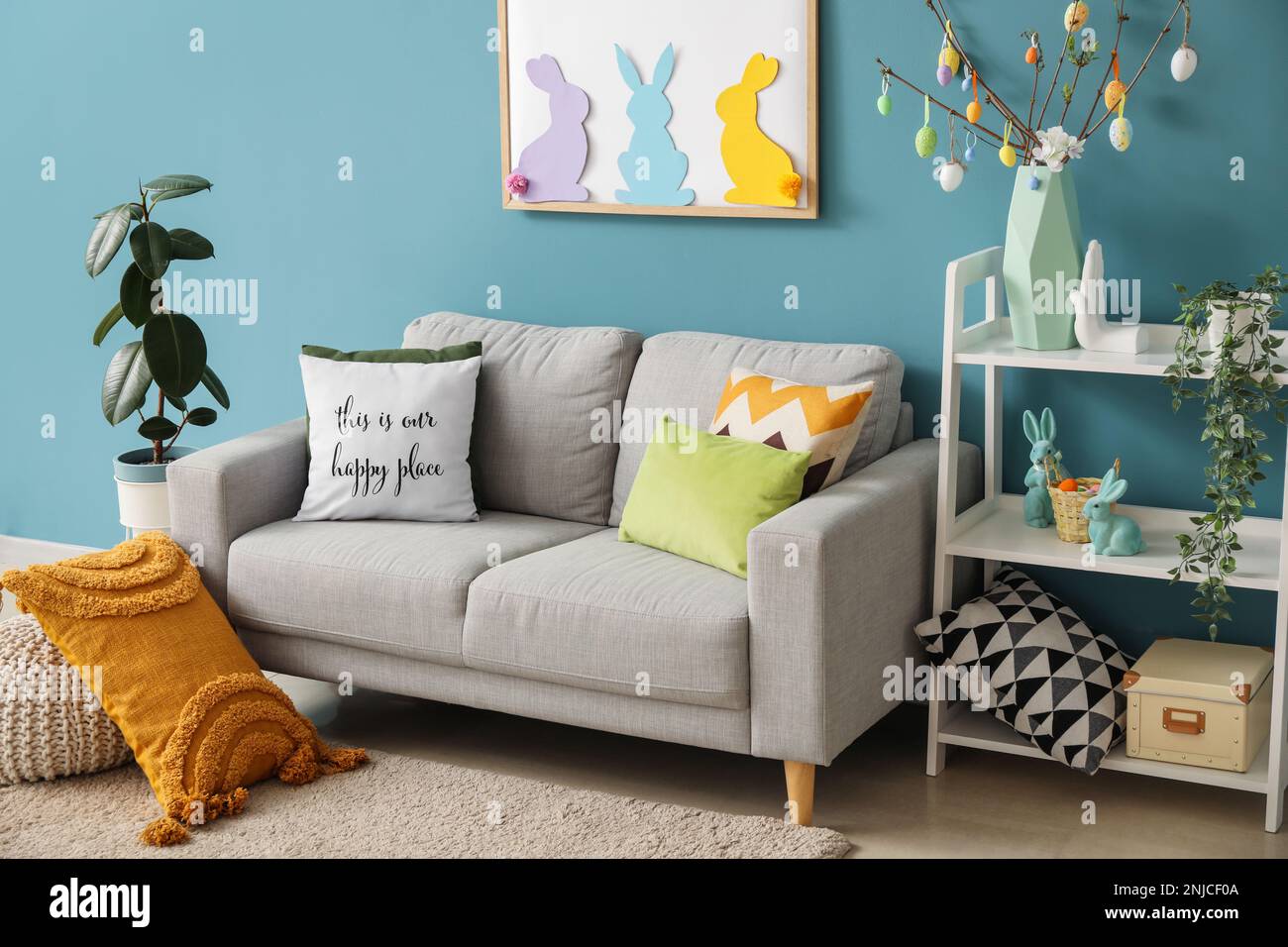 Interior of living room with Easter decor, sofa and shelving unit Stock ...
