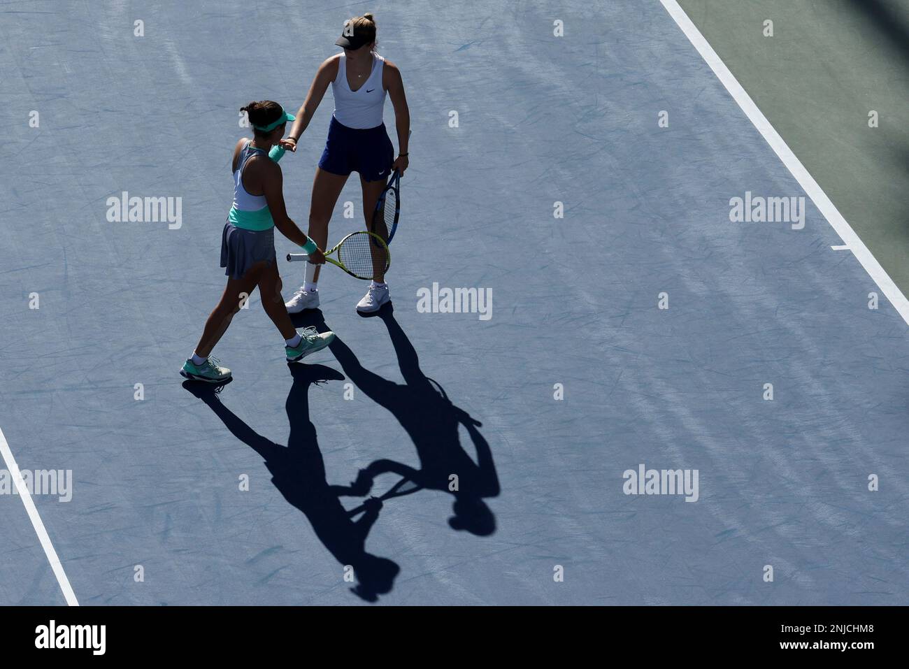Malak El Allami and Ella McDonald react during a junior girls' doubles ...