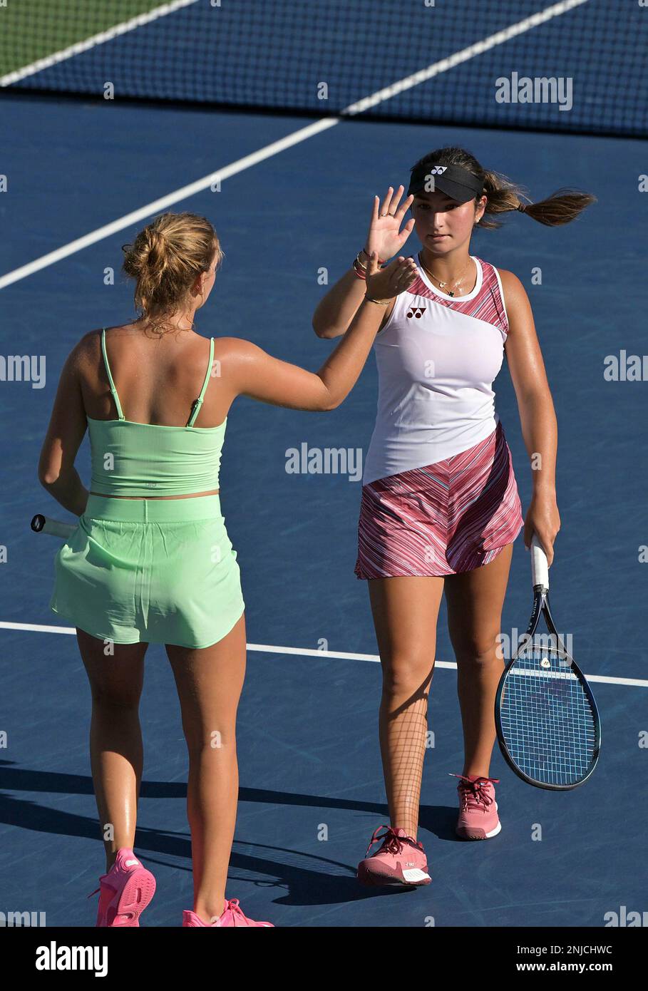 Natalie Block and Piper Charney high five during a junior girls ...