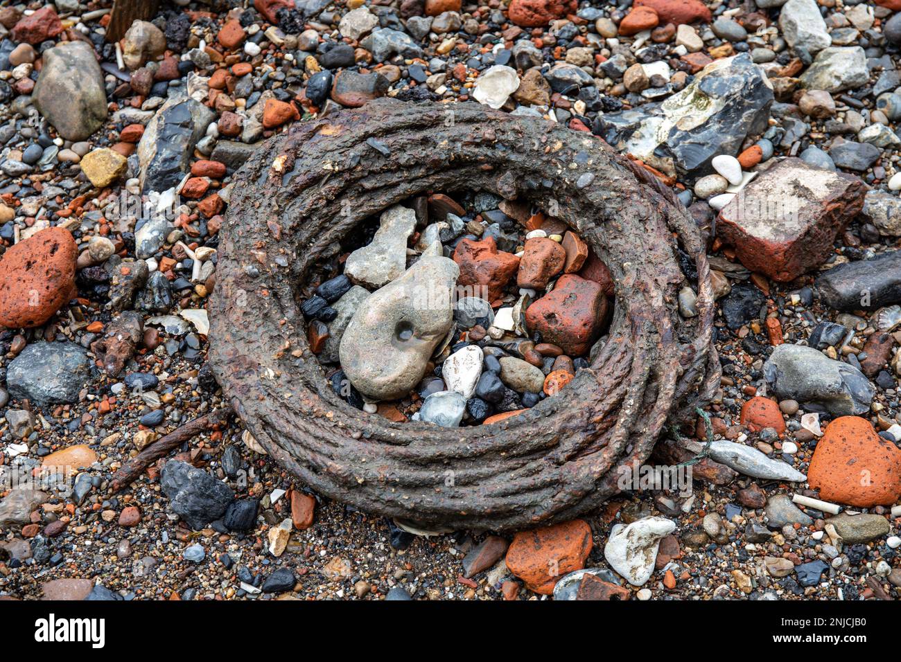 Rusty old cord on River Thames foreshore during low tide in London ...