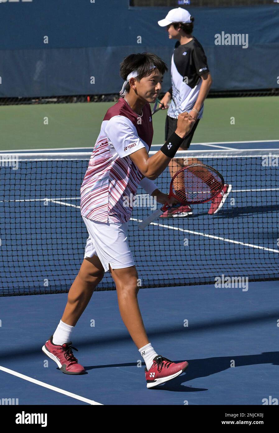Aidan Kim reacts during a junior boys' doubles match at the 2022 US ...