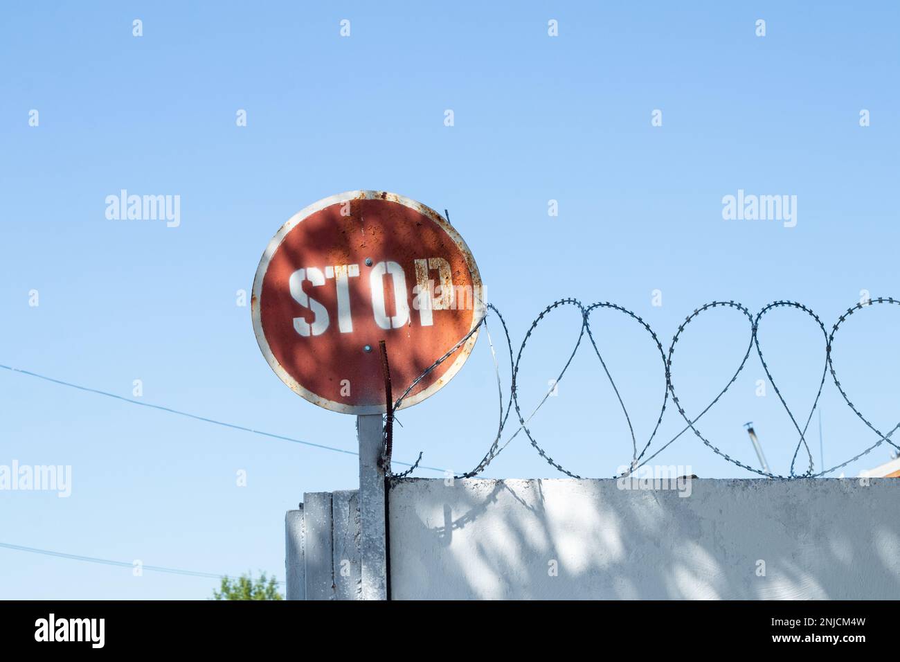stop sign and barbed wire on the fence against Stock Photo - Alamy