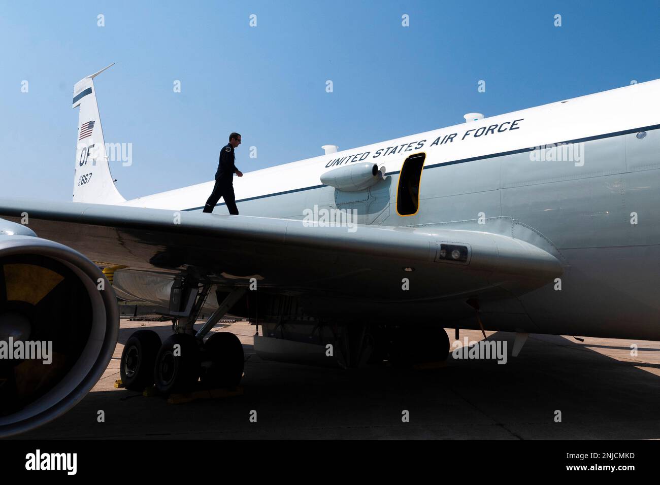 A airman walks along the wing of now retired WC-135C/W, during a ...