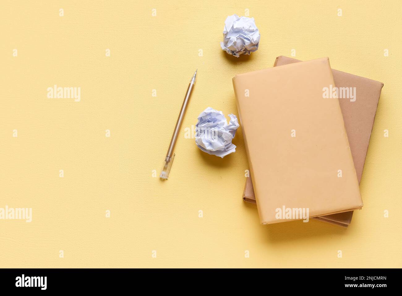 Pen, crumpled paper balls and books on color background. World Poetry ...