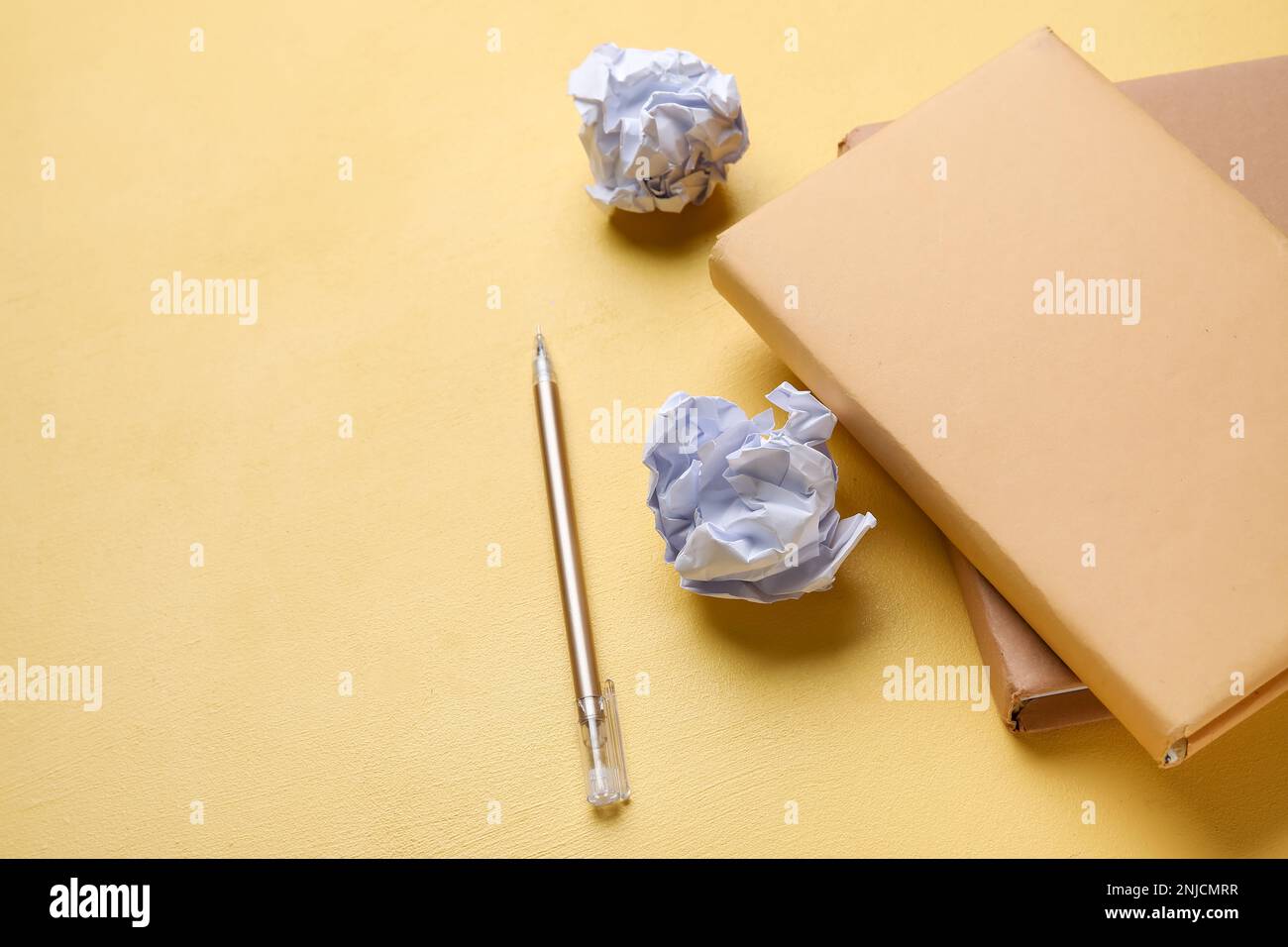 Pen, crumpled paper balls and books on color background. World Poetry ...