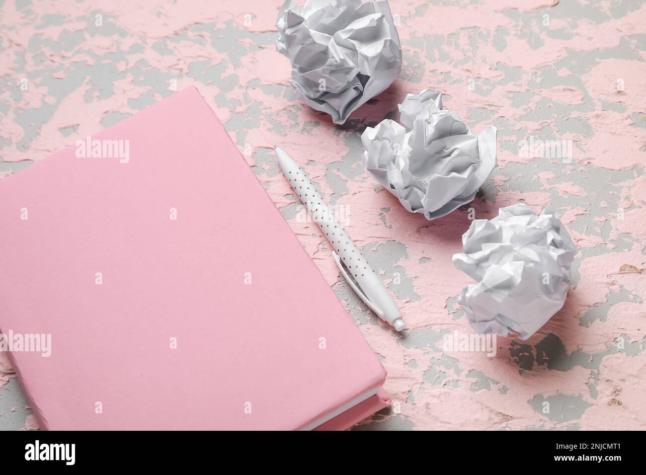 Blank book, crumpled paper balls and pen on grunge background, closeup ...