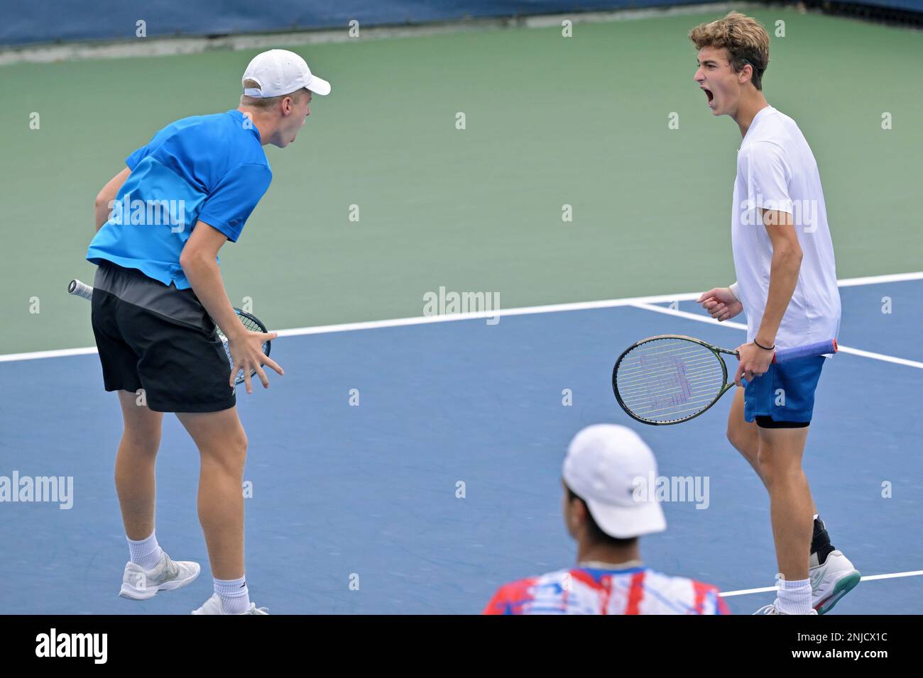 William Jansen and Patrick Brady react during a junior boys' doubles ...