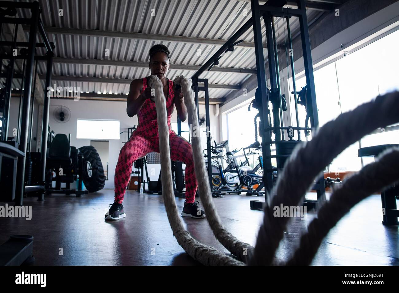 Woman doing training with naval rope. Abdominal strengthening and ...