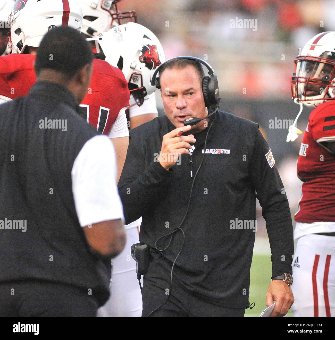 Arkansas State head coach Butch Jones talks on his headset during the ...