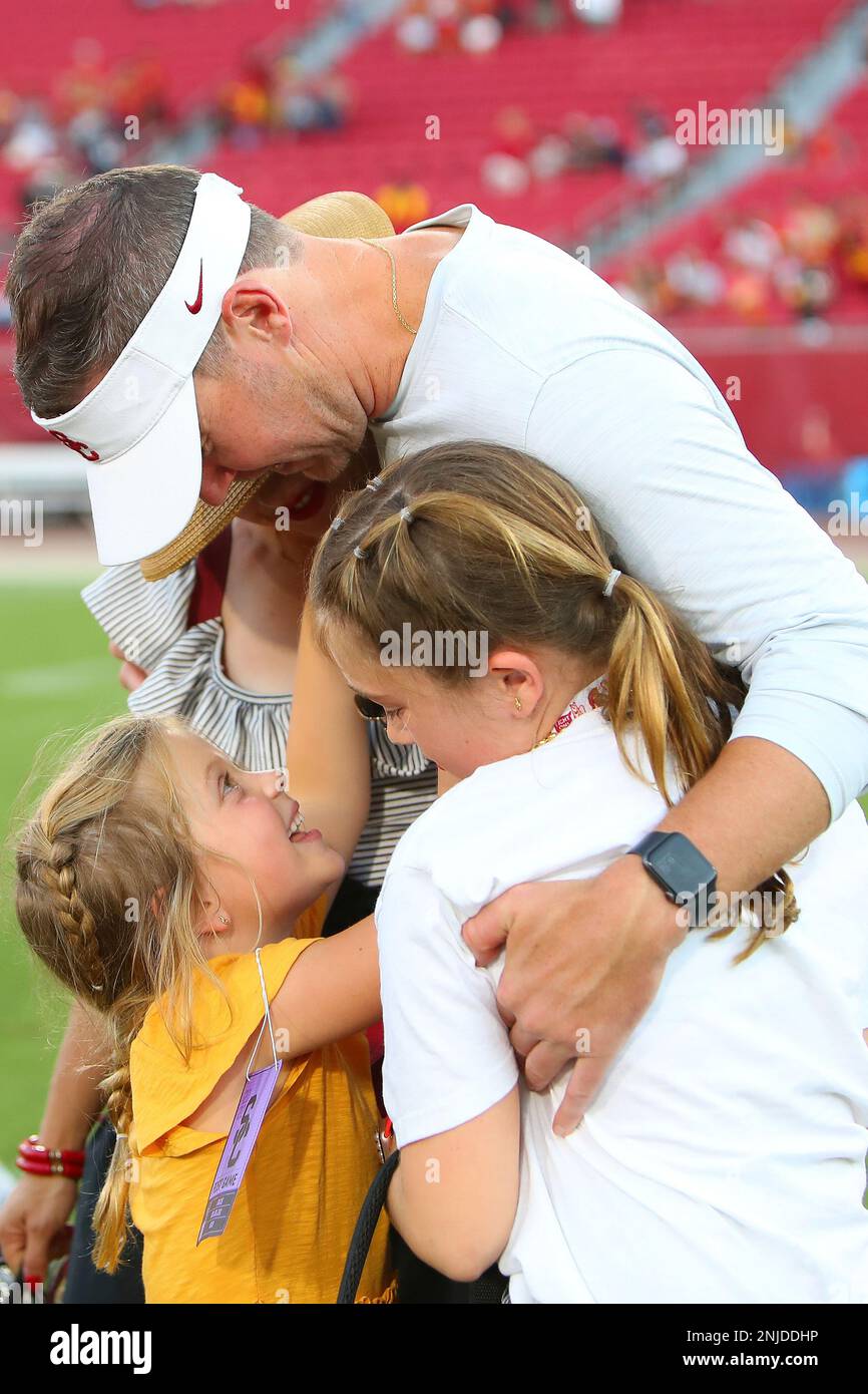 USC Trojans head coach Lincoln Riley hugs his daughters Stella (L) and ...