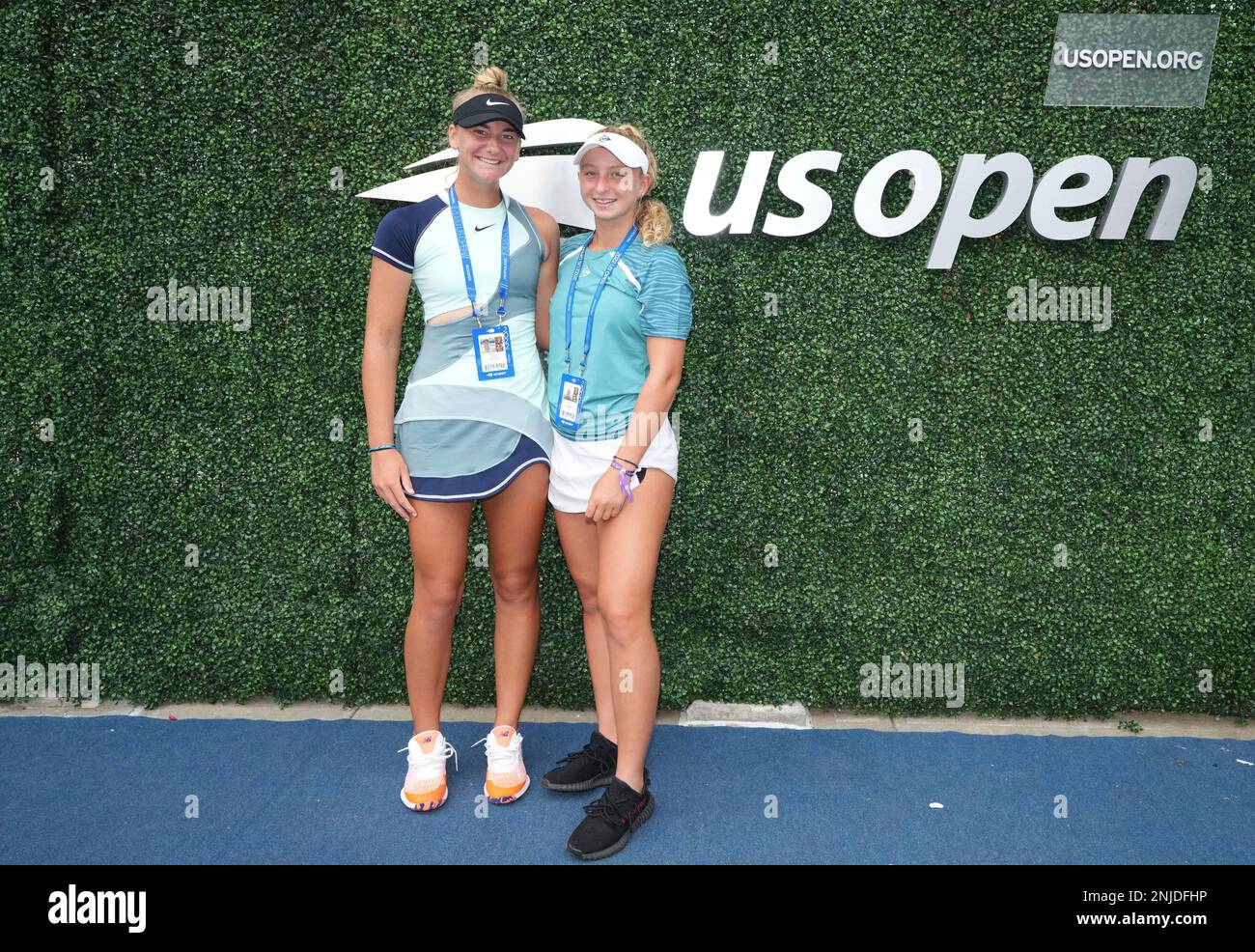 Ava Krug and Valeria Ray pose for a photo on the blue carpet during a ...