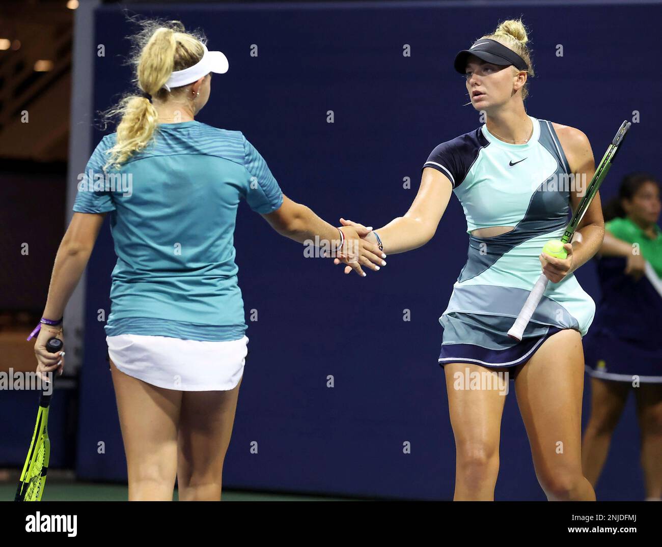 Valeria Ray and Ava Krug react during a junior girls' doubles match at ...