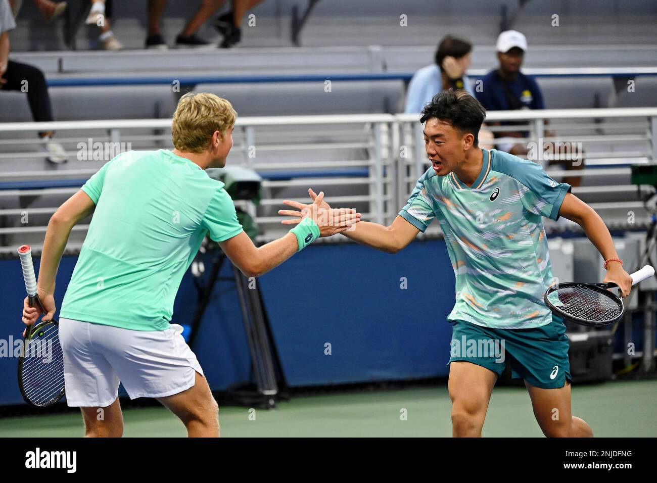 Edas Butvilas and Coleman Wong high five during a junior boys' doubles ...