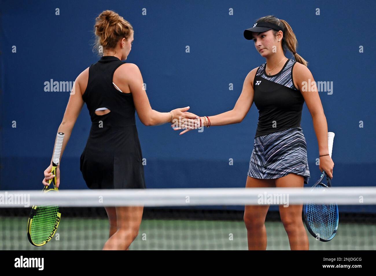 Piper Charney and Natalie Block high five during a junior girls ...
