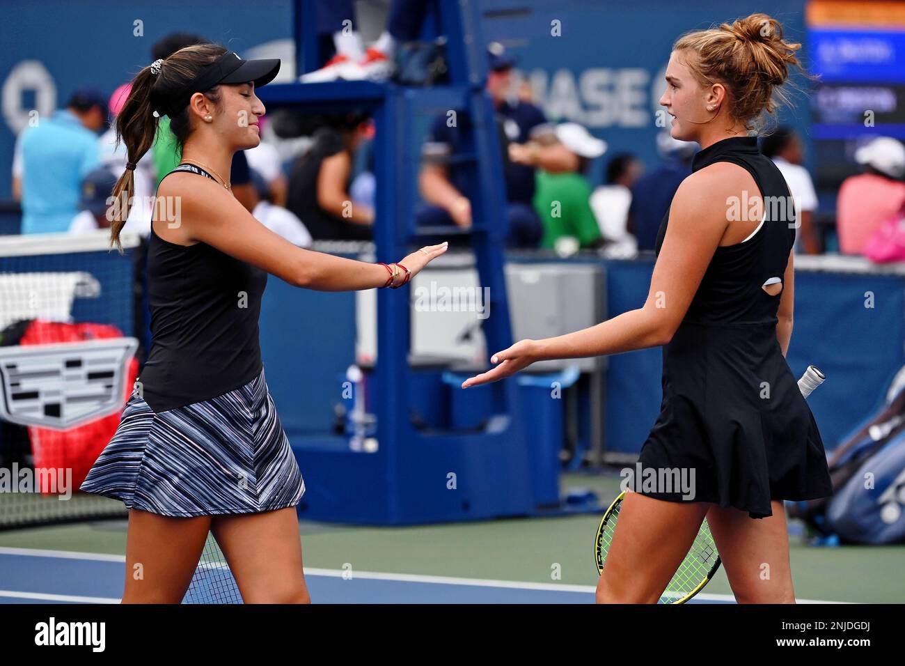 Natalie Block and Piper Charney high five during a junior girls ...