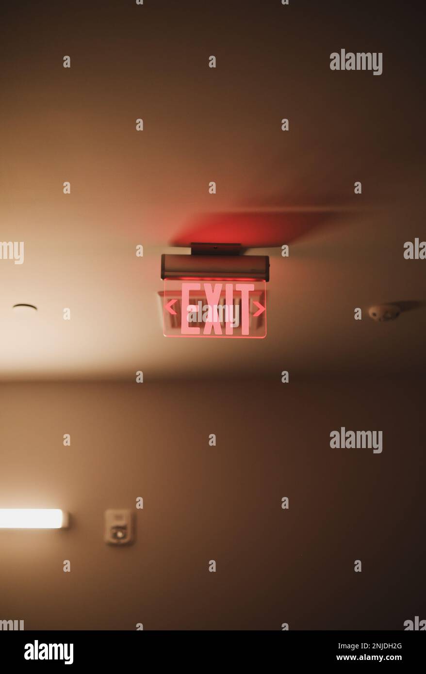 Hallway exit sign vibrant in corridor showing evacuation during ...