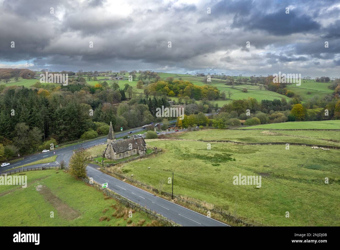 Aerial view of a small stone church nestled in the rolling hills of the ...