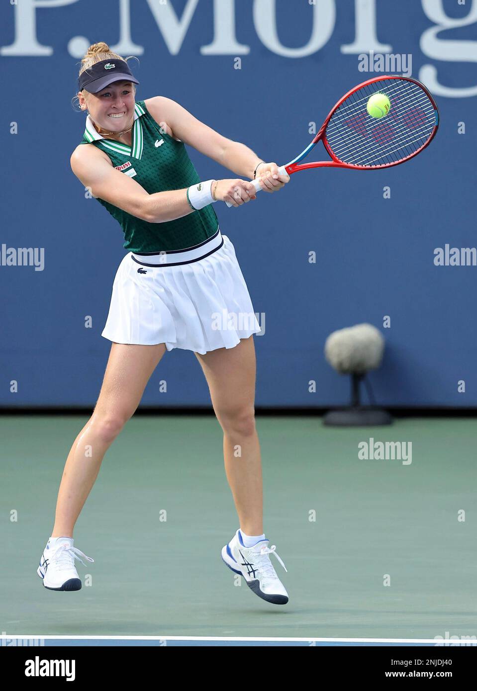 Celine Naef returns during a junior girls' singles match at the 2022 US ...