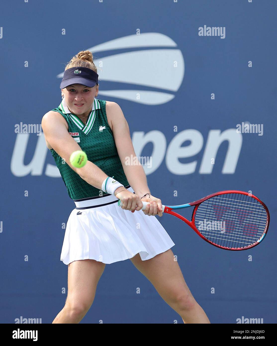 Celine Naef returns during a junior girls' singles match at the 2022 US ...