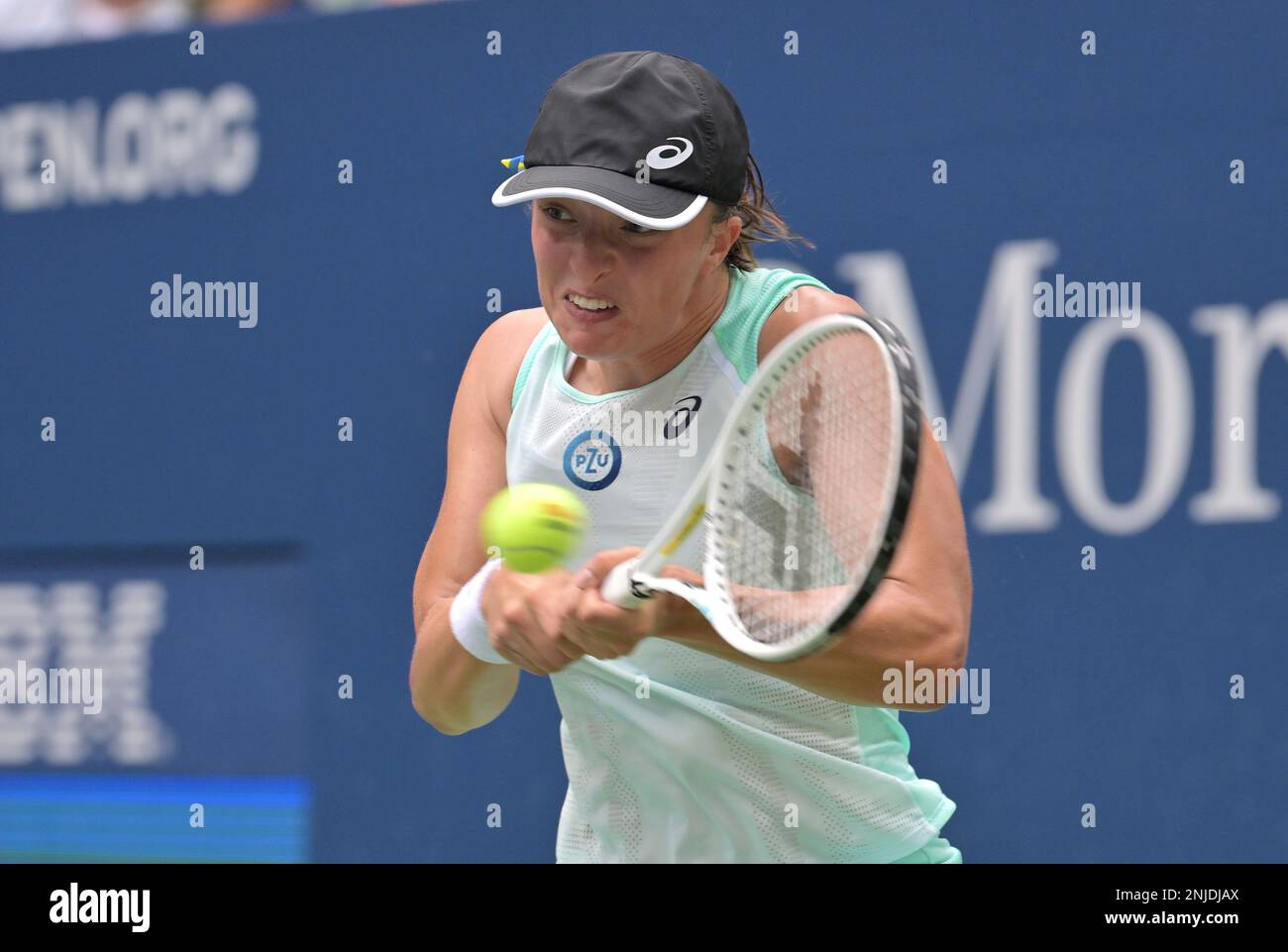 Iga Swiatek hits a backhand during a women's singles match at the 2022 ...