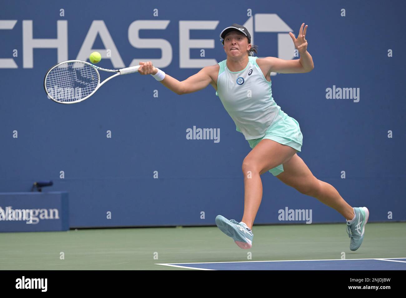 Iga Swiatek hits a forehand during a women's singles match at the 2022 ...