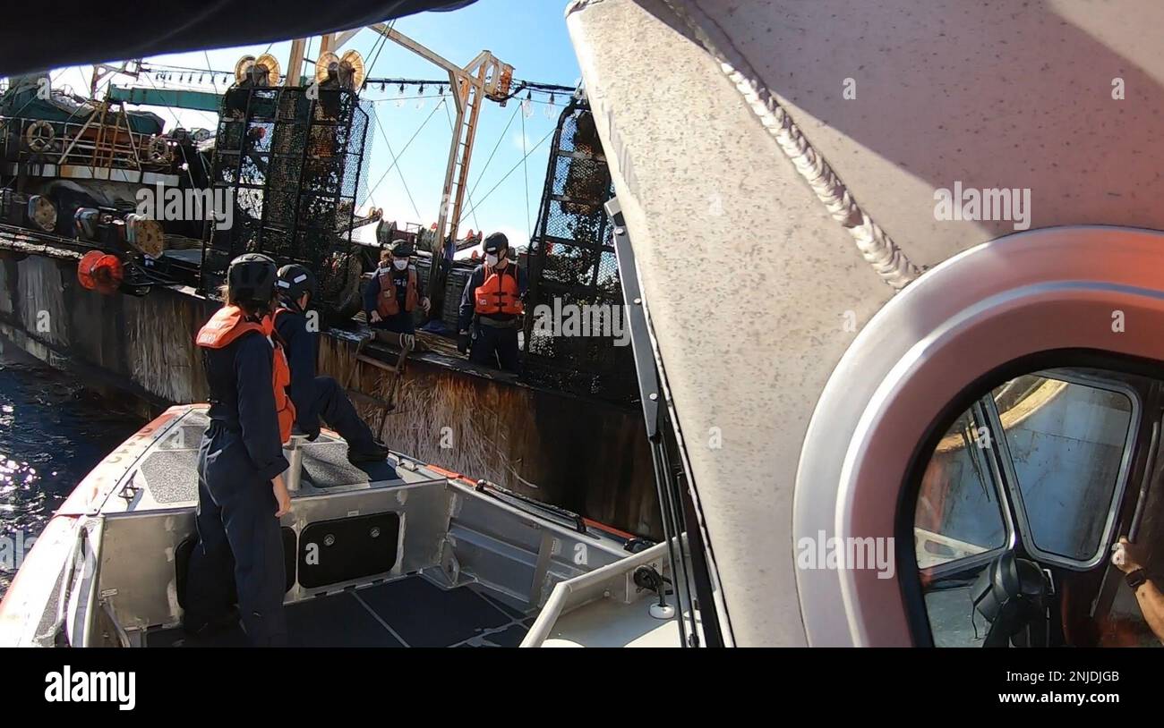 U.S. Coast Guard members conduct a boarding of a fishing vessel in the ...