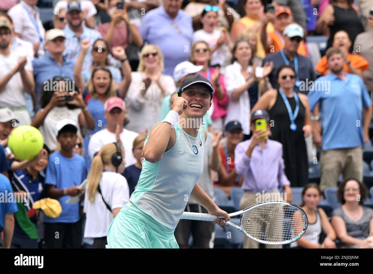 Iga Swiatek reacts to winning a women's singles match at the 2022 US ...