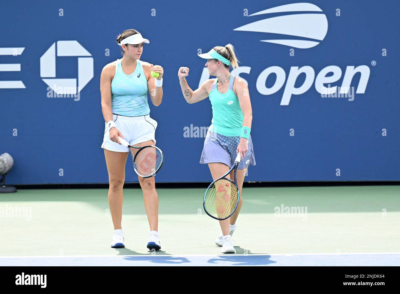 Caroline Dolehide and Storm Sanders fist bump during a women's doubles ...