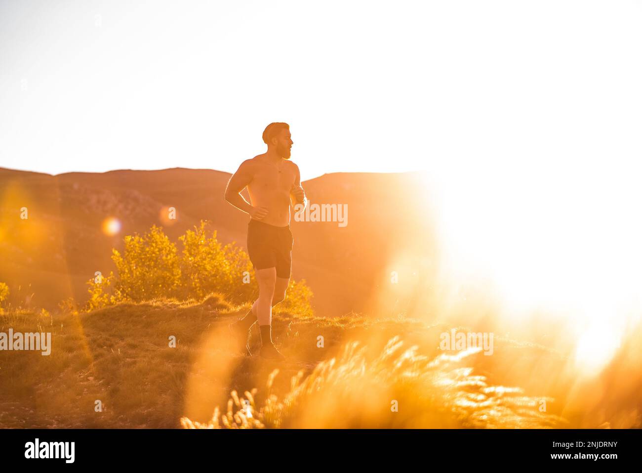 Athletic young man running in the nature. Healthy lifestyle Stock Photo ...