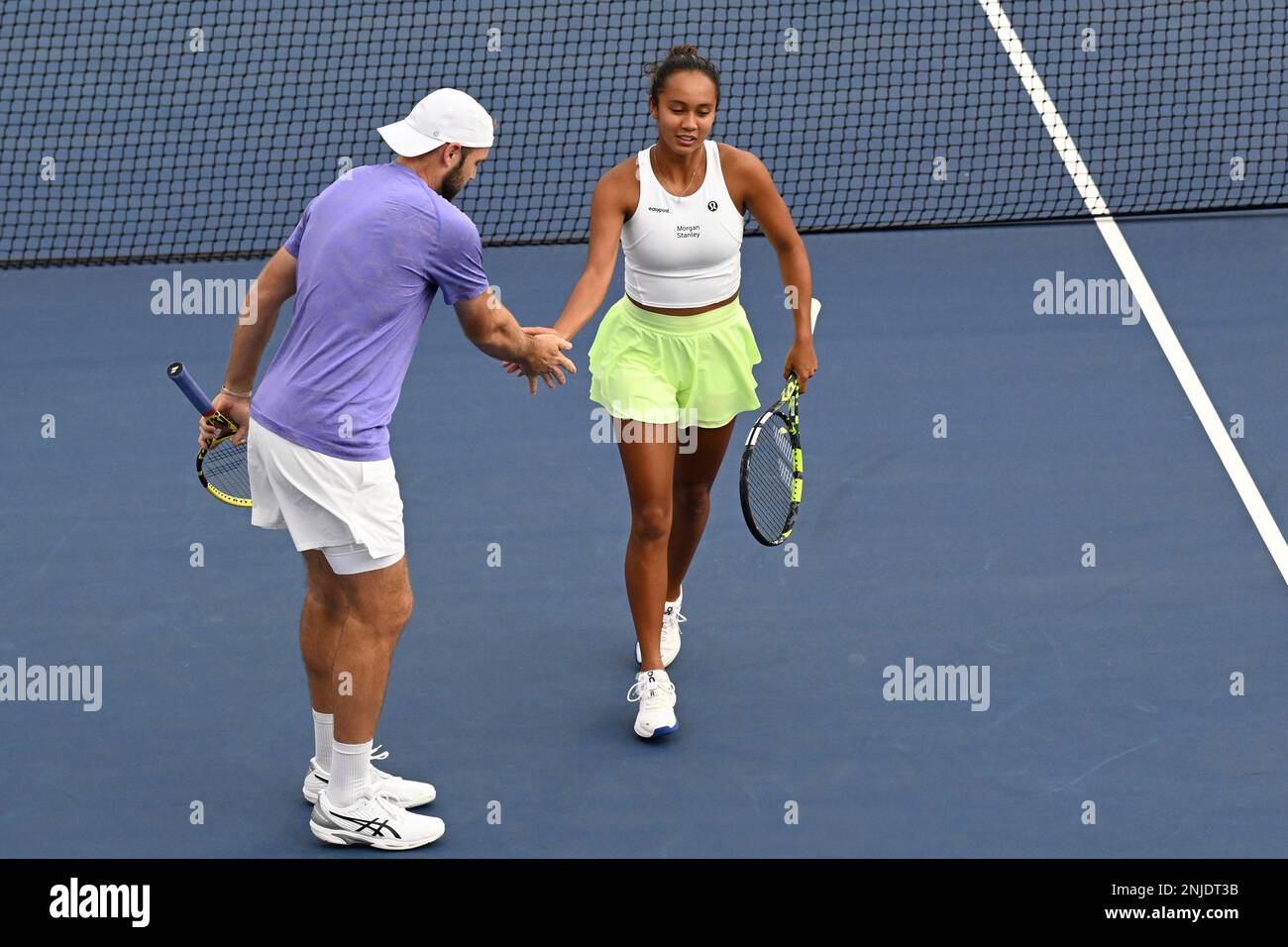 Jack Sock and Leylah Fernandez high five during a mixed doubles match ...