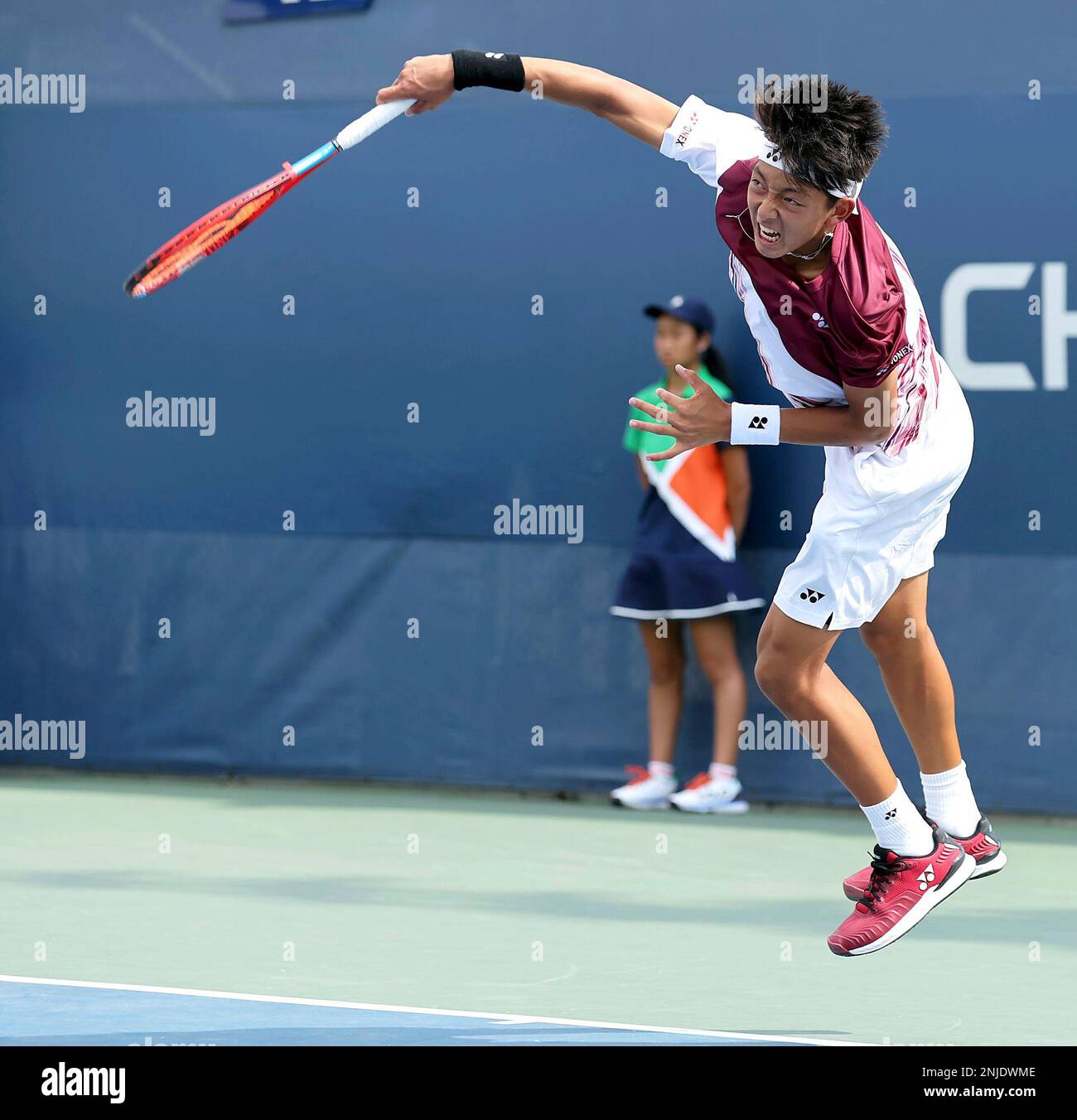 Aidan Kim serves during a junior boys' singles match at the 2022 US ...