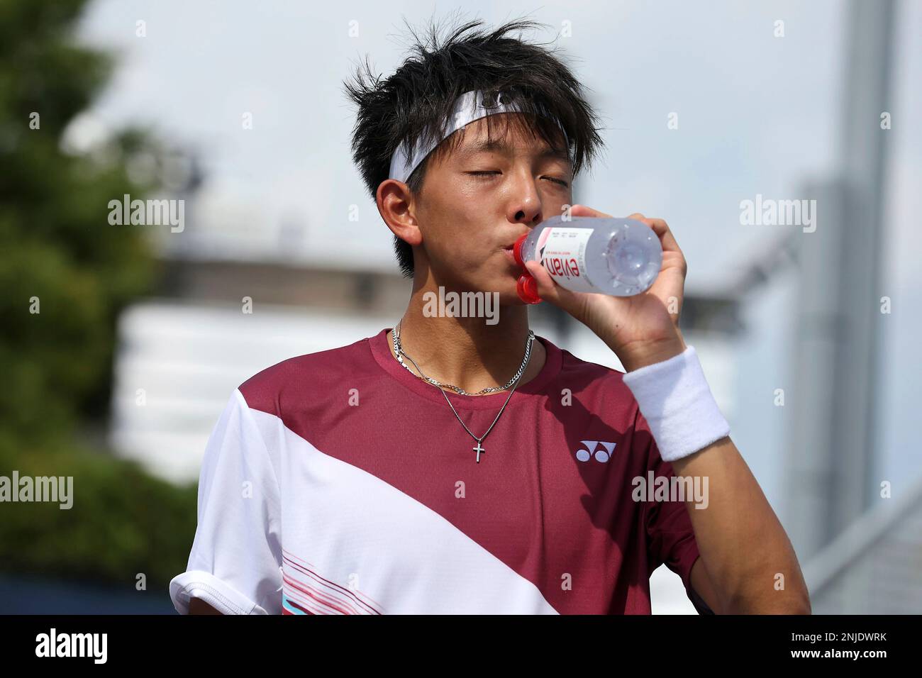 Aidan Kim drinks water during a junior boys' singles match at the 2022 ...