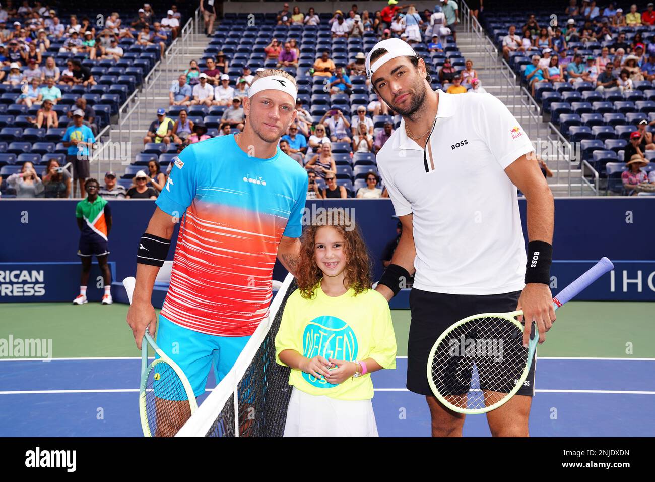 Alejandro Davidovich Fokina and Matteo Berrettini pose with a kid during a men's singles match ...