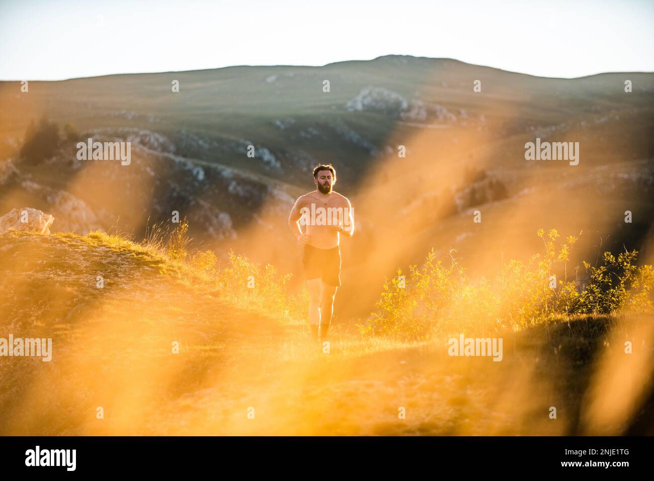 Athletic young man running in the nature. Healthy lifestyle Stock Photo ...