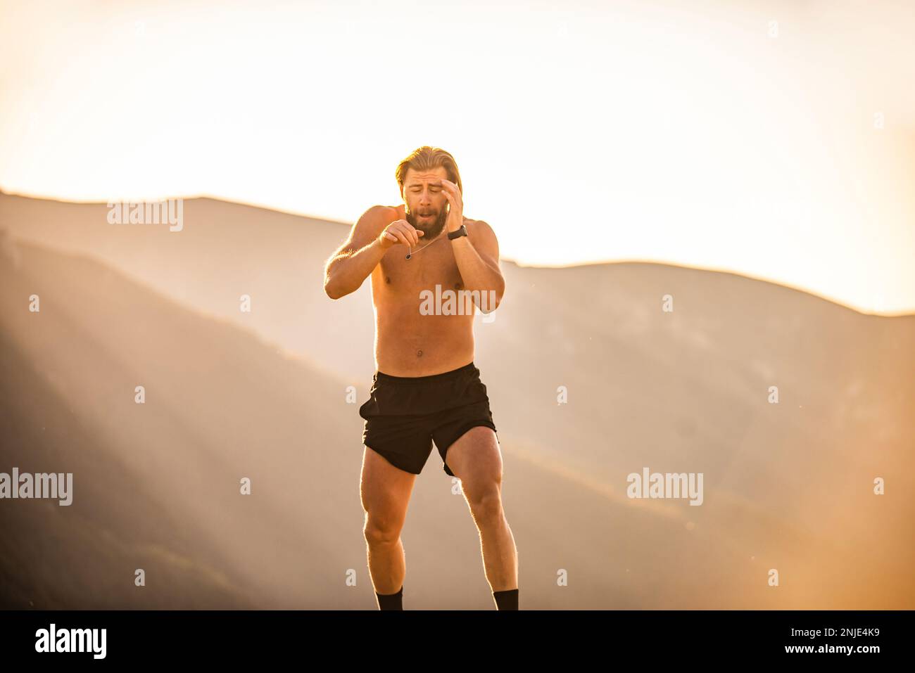 Man boxing with shadow exercising at sunset outdoor. Port victory ...
