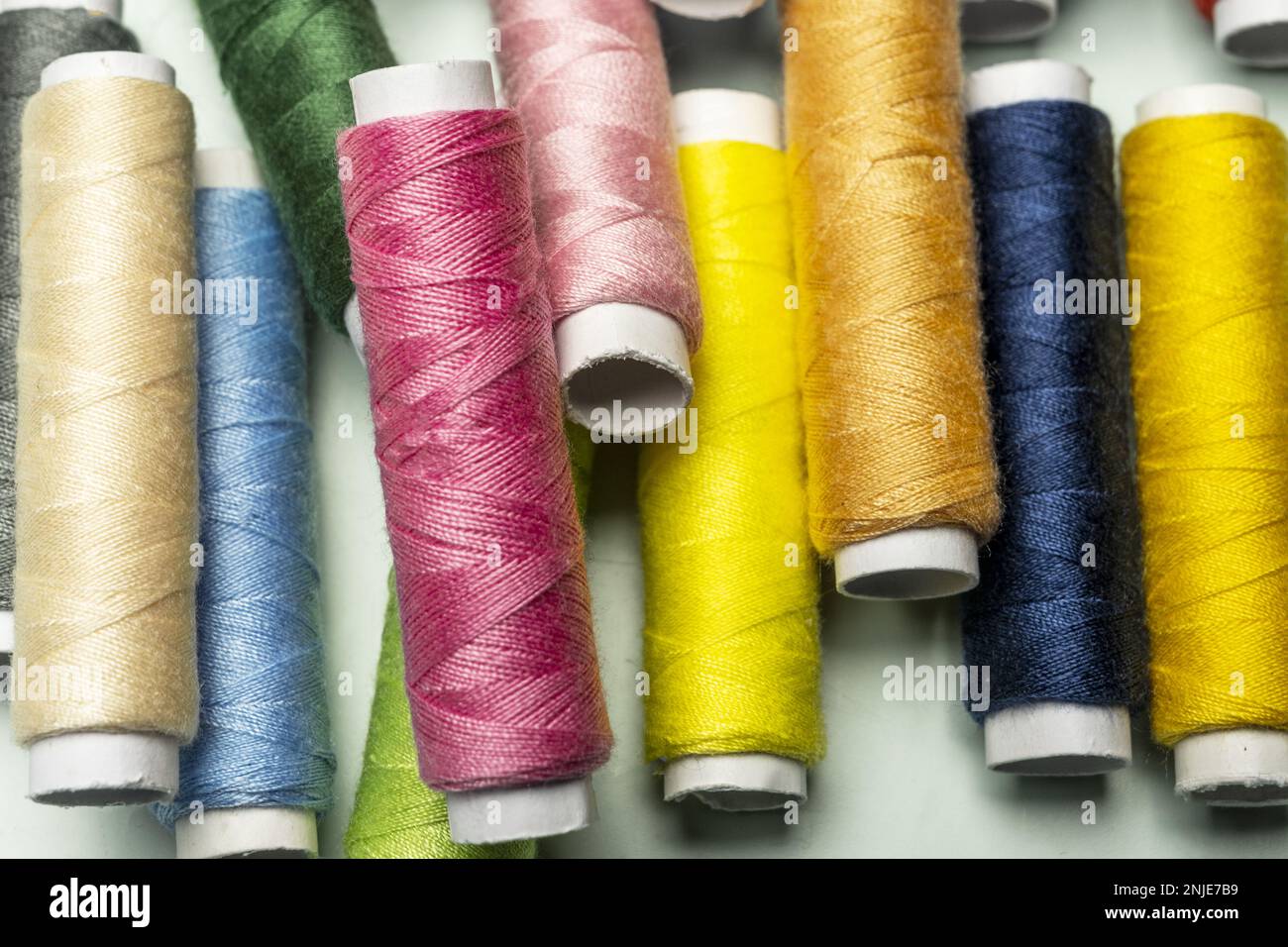 Brand new spools of various colored sewing thread Stock Photo - Alamy