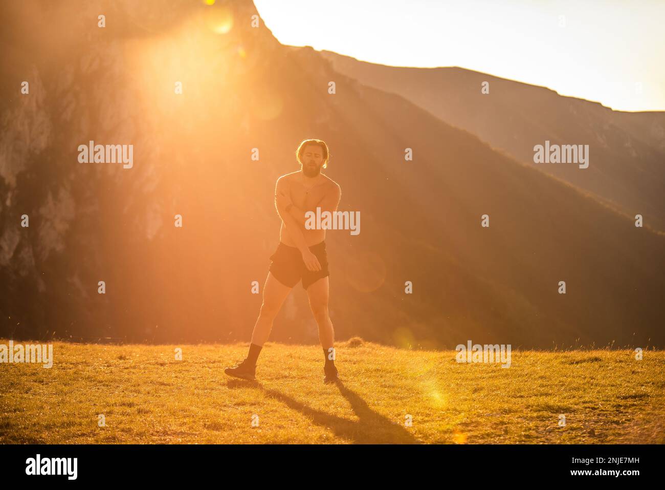 Man boxing with shadow exercising at sunset outdoor. Port victory ...