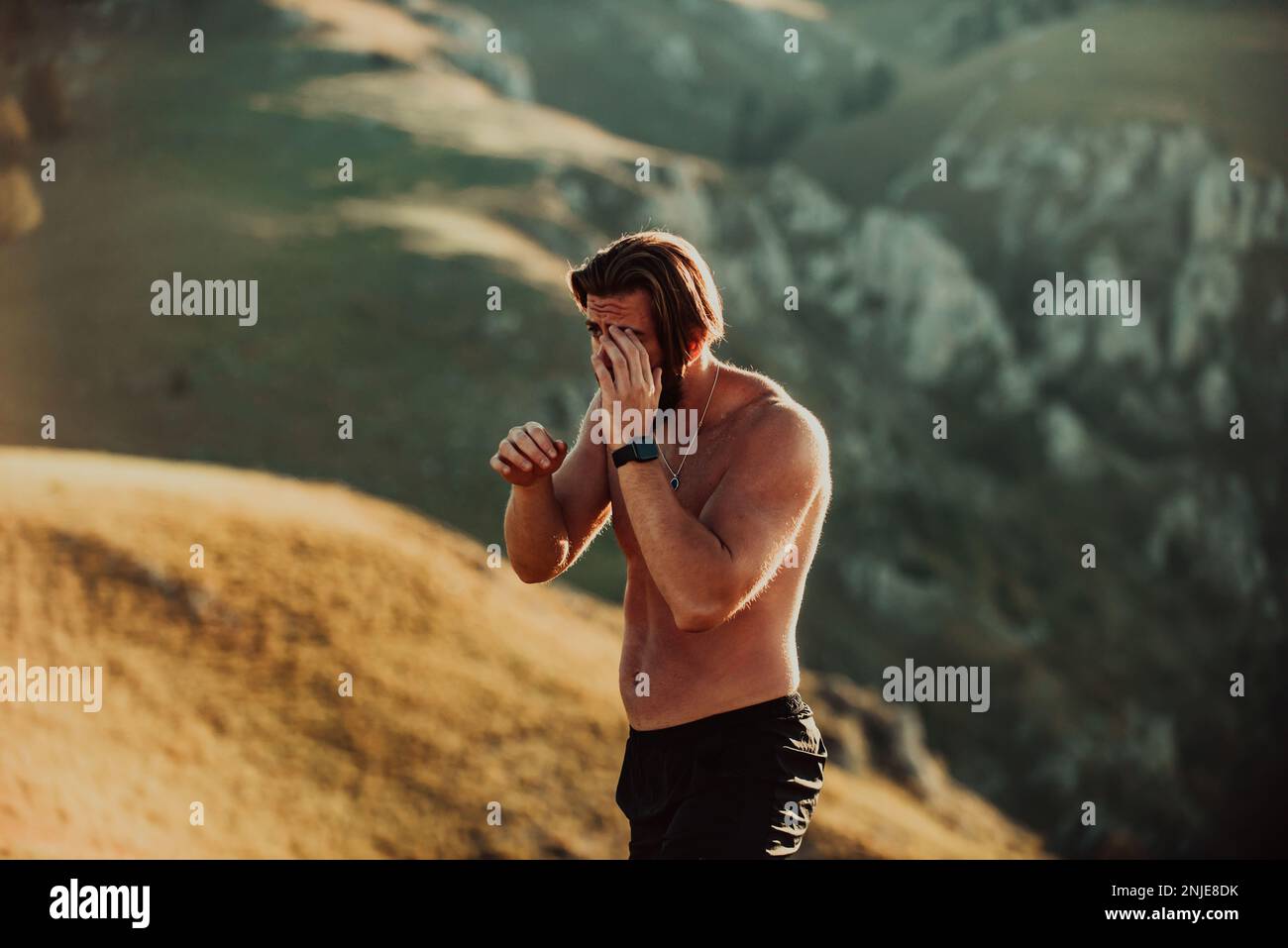 Man boxing with shadow exercising at sunset outdoor. Port victory ...