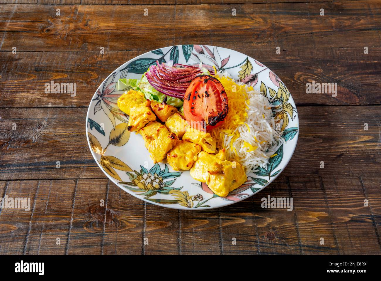 A plate of chicken skewers cooked on the grill in the middle eastern ...