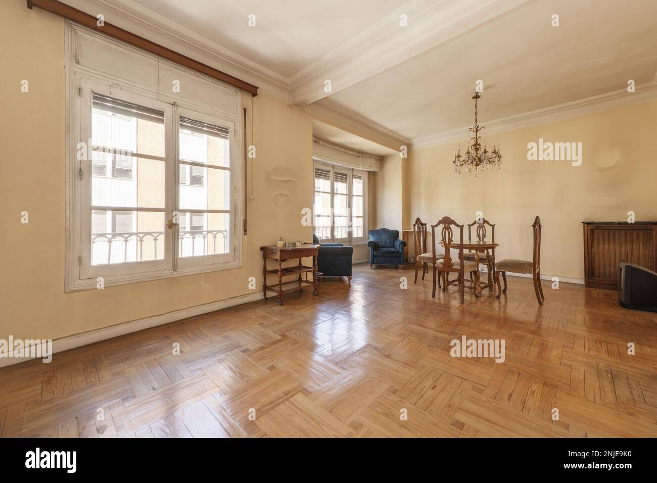 Living room of a house with a few loose wooden furniture, some chairs ...
