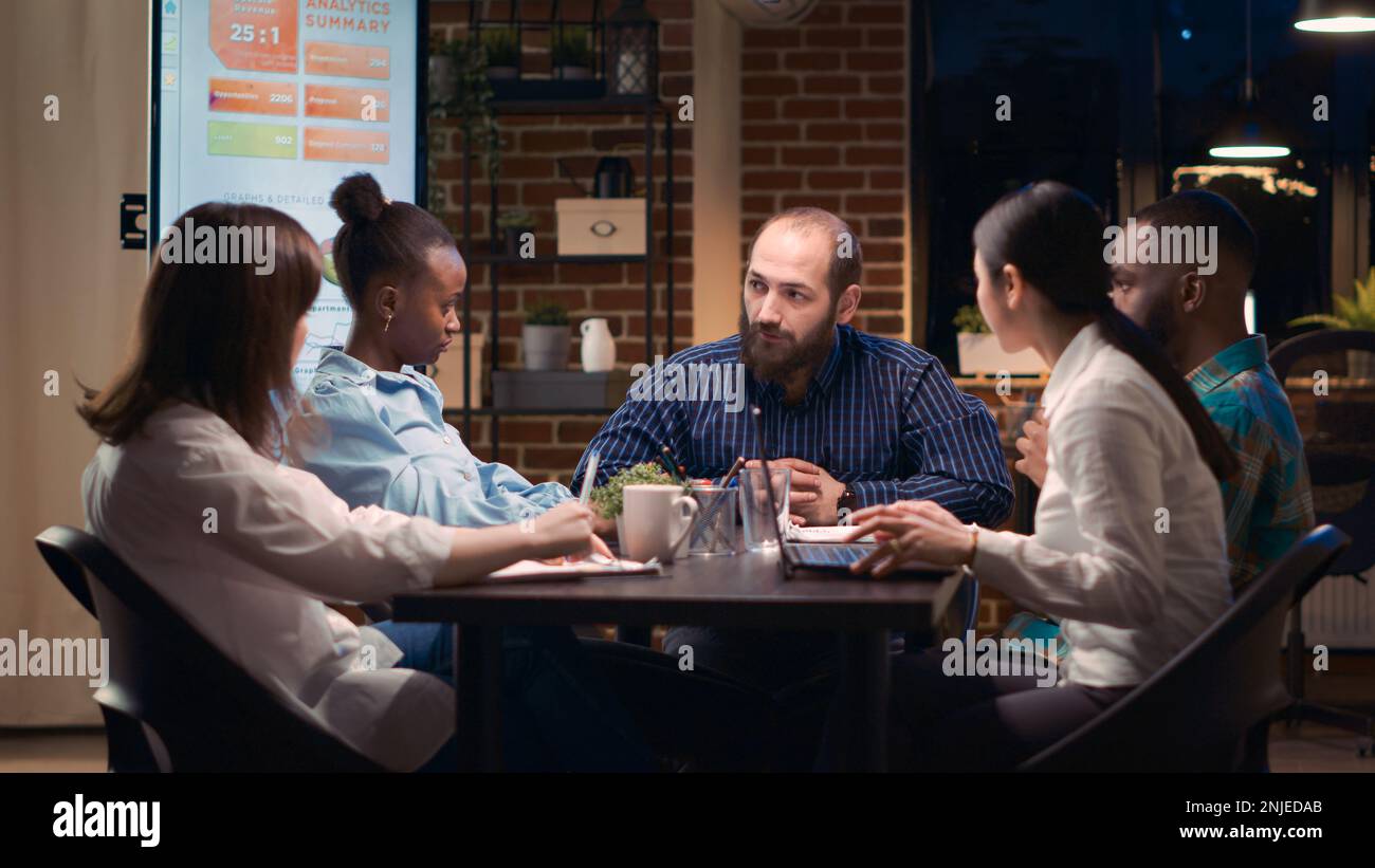 Diverse Coworkers Brainstorming Team Leader Explaining Strategy Plan In Business Meeting